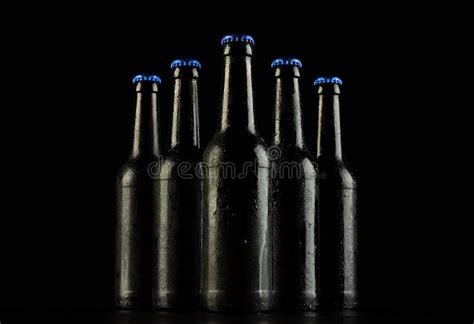 Image Of Five Beer Bottles With Blue Crown Caps With Copy Space On
