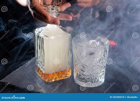 The Bartender Mixes Whiskey With Smoke To Give A Special Taste To The