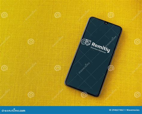 Remitly App Launch Screen On Smartphone On Yellow Fabric Background