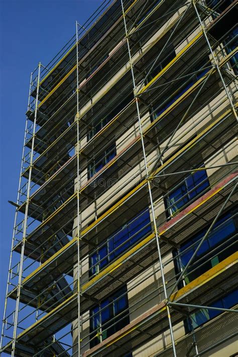 Scaffolding Structure On A Modern Building Under Renovation With Metal