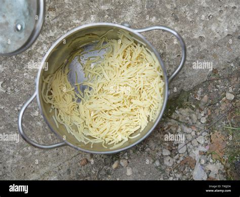 Half Empty Casserole With Cooked Noodles Placed On The Cement Flkoor