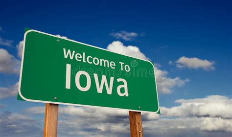 Welcome To Iowa Green Road Sign Over Blue Sky With Some Clouds Stock