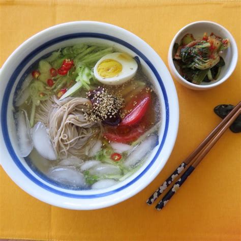 A Bowl Of Ramen With Chopsticks And An Egg On The Side Next To It