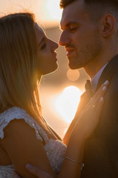 Premium Photo The Bride And Groom Together Meet The Sunset
