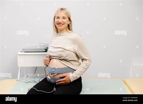 Woman Pregnant Checking Fetal Heart Beat By Fetal Monitoring Expectant Mother With Midwife