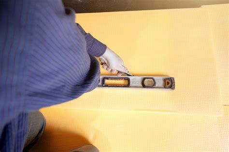 Close Up Of The Master Cuts The Size Of Expanded Polystyrene On The Floor The Process Of Floor