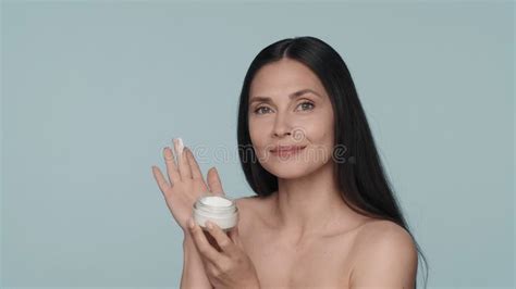 Cream For Skin Care A Seminude Brunette Woman Applies Cream To Her