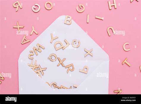 Opened White Envelope With Many Abc Letters On Pink Background Correspondence Concept Flat Lay