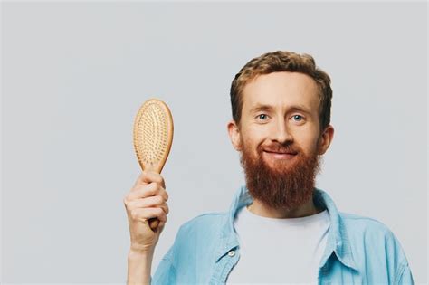 Premium Photo Portrait Of A Man With A Massage Comb In His Hands