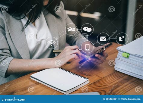 Women Are Using A Mobile Phone Wifi Connection On The Desk In The