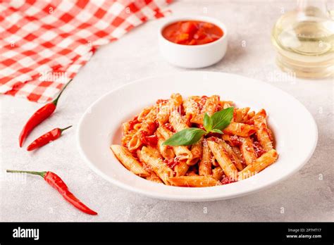 Classic Italian Pasta Penne Alla Arrabiata With Fresh Basil On A Light