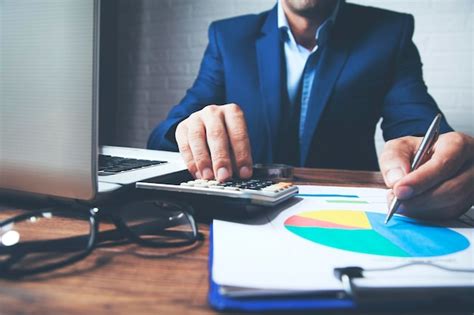 Premium Photo Man Hand Graph And Calculator