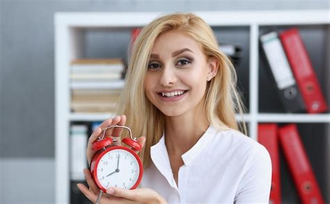 Premium Photo Smiling Business Woman Holding In Hand Clock