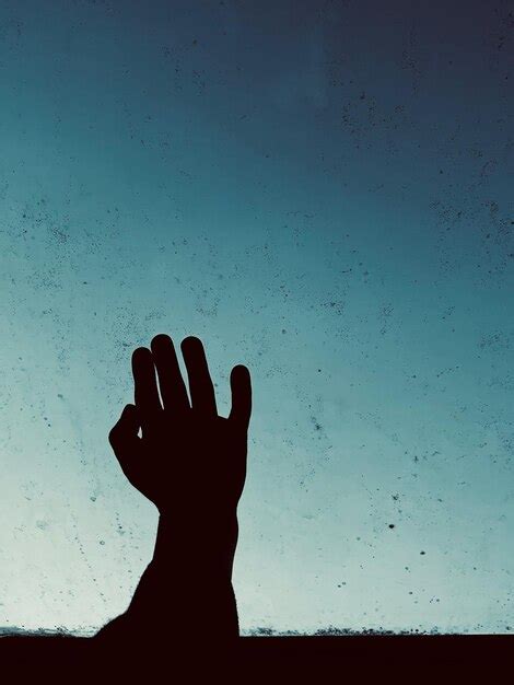 Premium Photo Cropped Hand Touching Window Against Clear Blue Sky