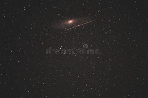 Meteor Shower During Perseid Curent Andromeda Galaxy In The Night Sky