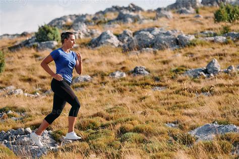 Empowered Runner Embracing Natures Beauty On A Serene Morning Trail