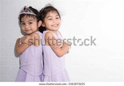 Female Asian Identical Twins Sitting On Stock Photo Shutterstock