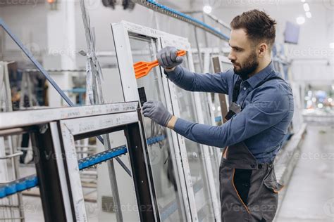 Factory Worker Assembling Aluminum And Pvc Window Frame 54312945 Stock