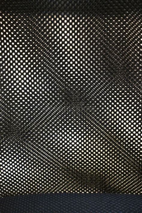 A Detailed Close Up Of A Textured Fabric With A Perforated Pattern Creating An Intriguing