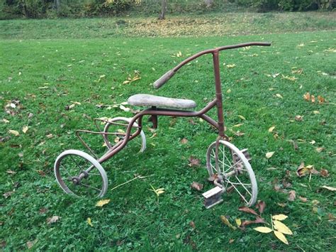 Premium Photo Rusty Tricycle In Grassy Field