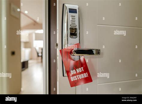 Close Up On The Opened Door With Modern Key Lock Of Hotel Motel Room With Do Not Disturb Sigh