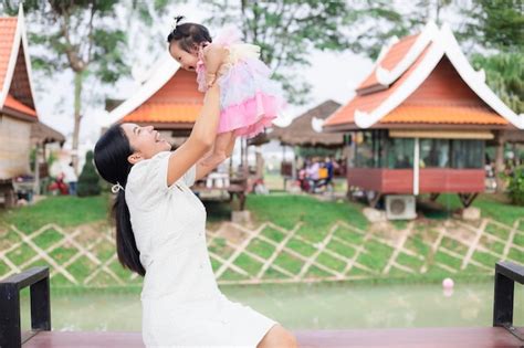 Joyeuse Petite Fille Asiatique étreignant Sa Mère Dans Le Parc Heureuse
