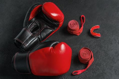 Premium Photo Red Boxing Gloves Cap And Bandage On A Black Background