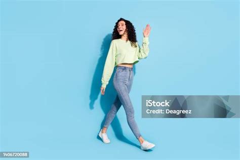 쾌활한 소녀의 전체 길이 프로필 사진 걷는 것은 푸른 색 배경에 고립 된 빈 공간 팔 손바닥 물결을 보입니다 갈색 머리에 대한 스톡 사진 및 기타 이미지 Istock