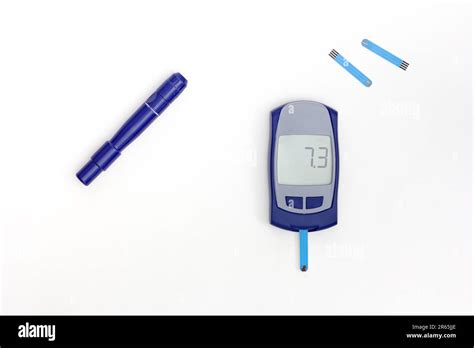 Top View Of Glucometer With 73 Result On Display With Blooded Test