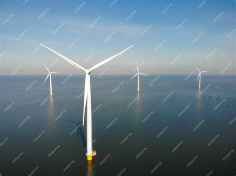 Premium Photo Offshore Windmill Park With Clouds And A Blue Sky