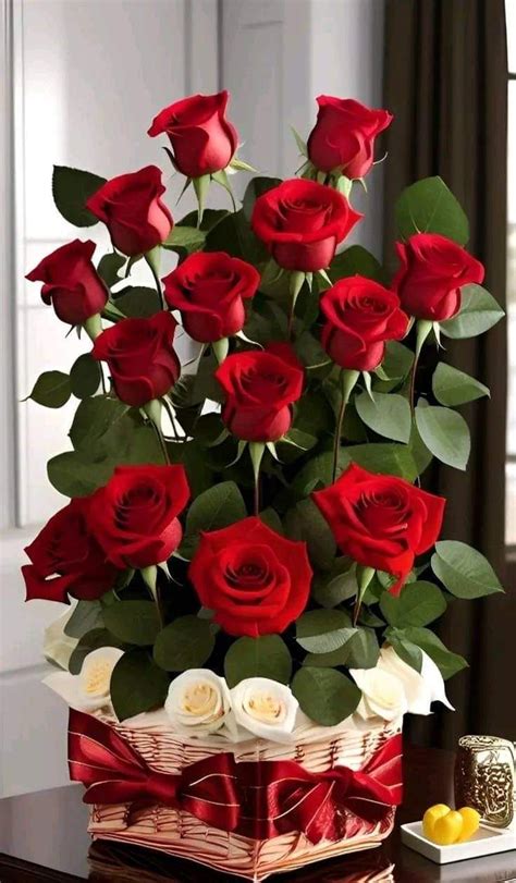 A Bouquet Of Red Roses Sitting On Top Of A Table Next To A Chocolate Box