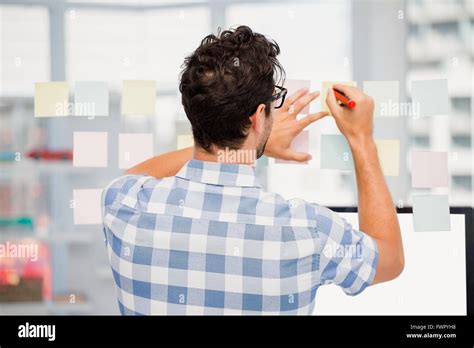 Rear View Of Man Writing On Sticky Notes Stock Photo Alamy