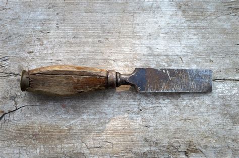 Premium Photo Old Chisel On A Wooden Table Tool