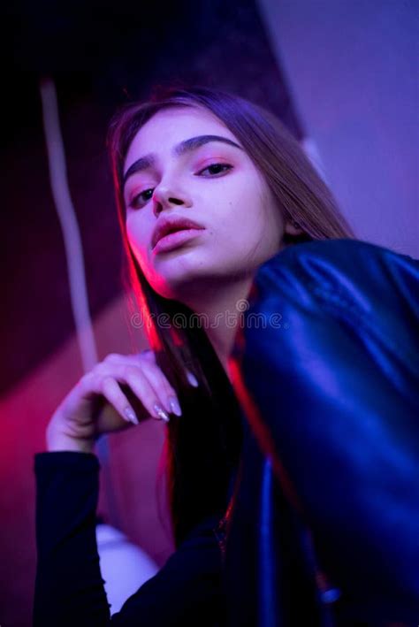 Young Beauty Girl Posing In Pink Neon Light Model Face Stock Image