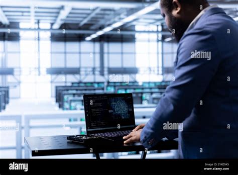 Computer Scientist In Data Center Using Laptop To Visualize Artificial Intelligence Neural