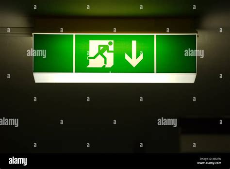 Emergency Exit Sign Glowing In The Dark Stock Photo Alamy
