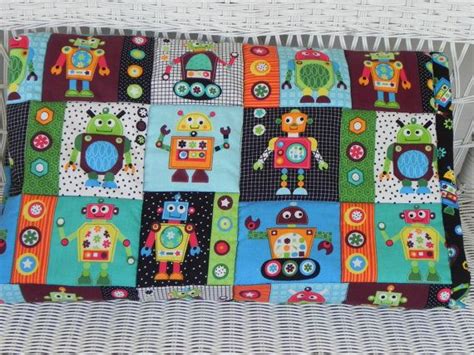 A Pillow Made To Look Like A Patchwork Quilt With Robots On It And