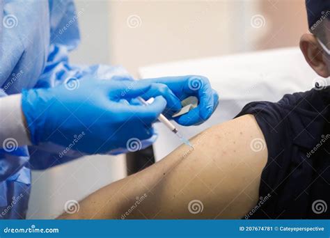 Details With A Man Getting An Intramuscular Injection With The Sars Cov 2 Vaccine In A Hospital