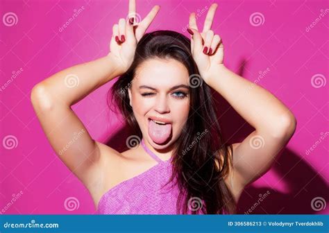 Woman Doing Funny Gesture With Finger Over Head As Bull Horns Crazy