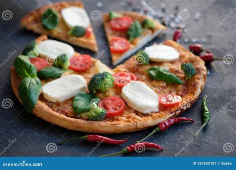 Sliced Pizza With Mozzarella Cheese Tomatoes Broccoli Spices And