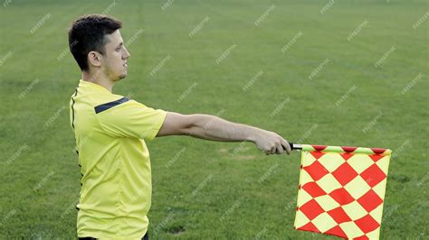 Premium Photo Assistant Referee Moving Along The Sideline During A