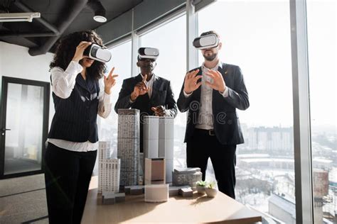Group Of Developers Using Virtual Reality Simulators Standing Around