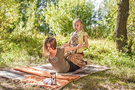Massage Therapist Performs A Relaxing Massage On The Forest Floor
