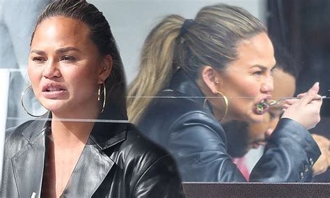 Chrissy Teigen Munches On A Green Salad While Enjoying An Outdoor Lunch In Beverly Hills With