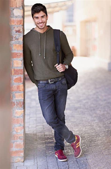 Between Classescropped Portrait Of A Handsome Young Man Standing