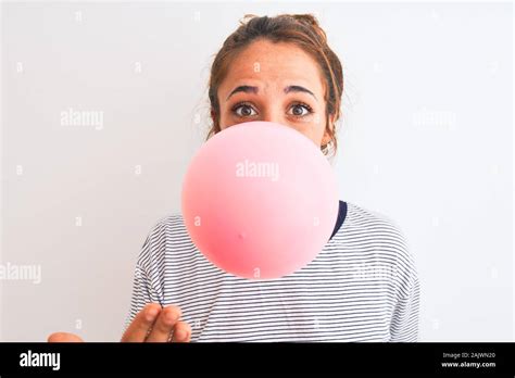 Young Redhead Woman Chewing Gum And Blowing Hair Bubble Over White Isolated Background Cover