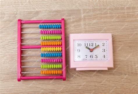 Premium Photo Plastic Colored Abacus And Clock On The Table