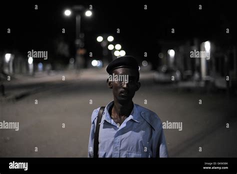 A Member Of The Somali Police Force Patrols Along A Street During An