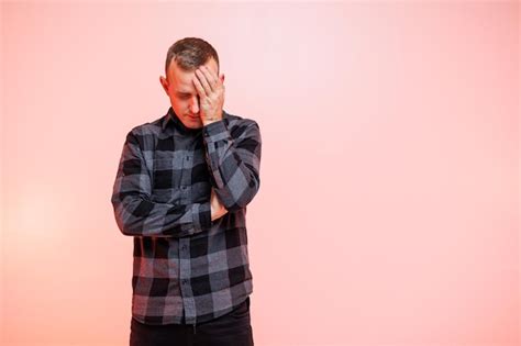 Premium Photo Young Positive Smiling Man In A Checkered Shirt On A