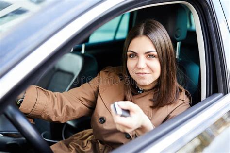 Woman Driver Holding Up Her Car Keys Out Of The Open Window Of The